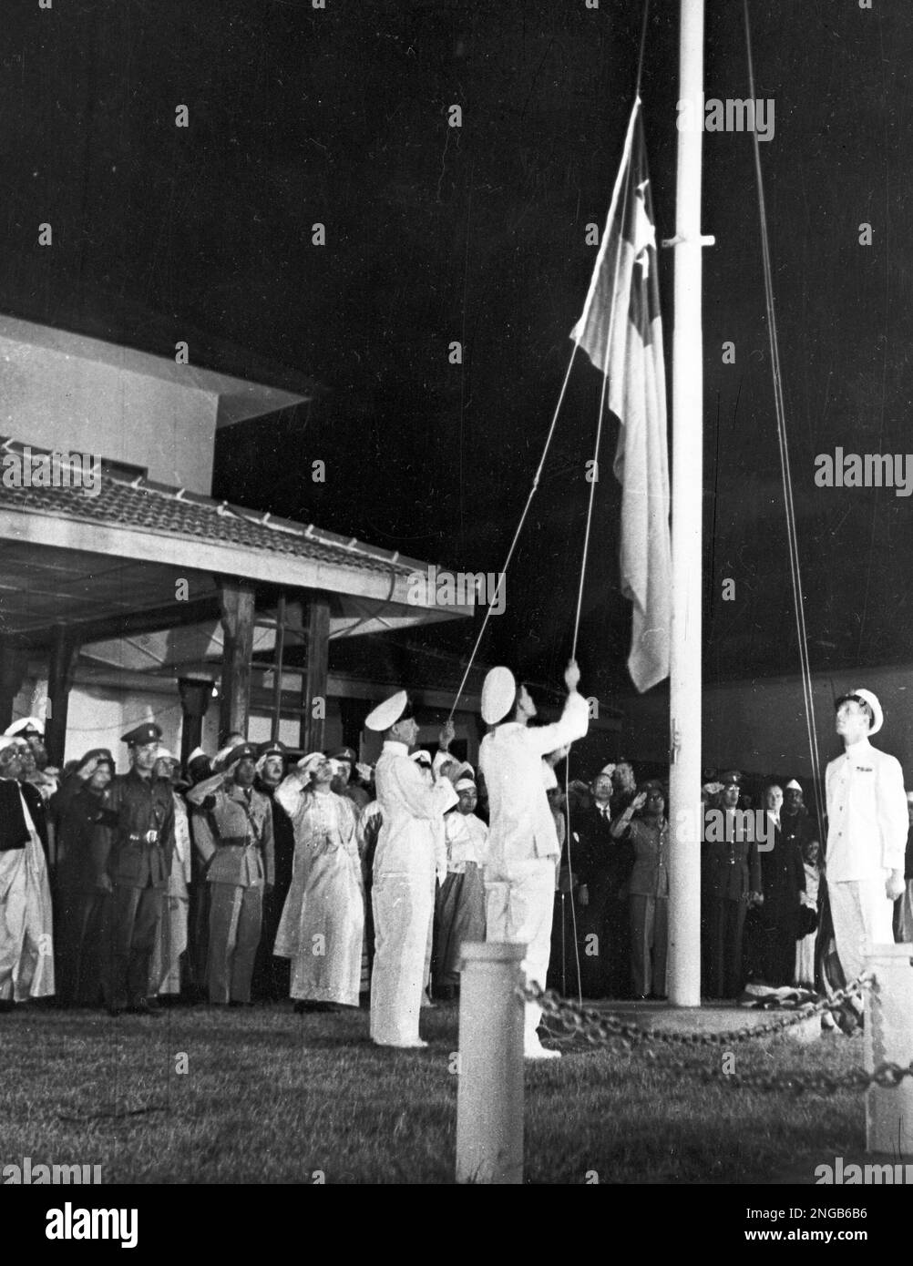 The flag of the Union of Burma is raised over the Houses of Parliament ...