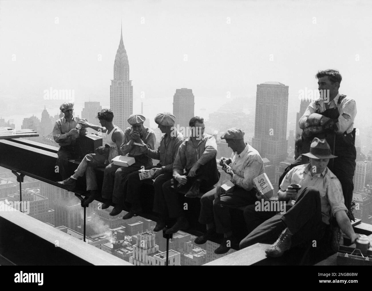 Construction workers take a lunch break on a steel beam atop the RCA ...