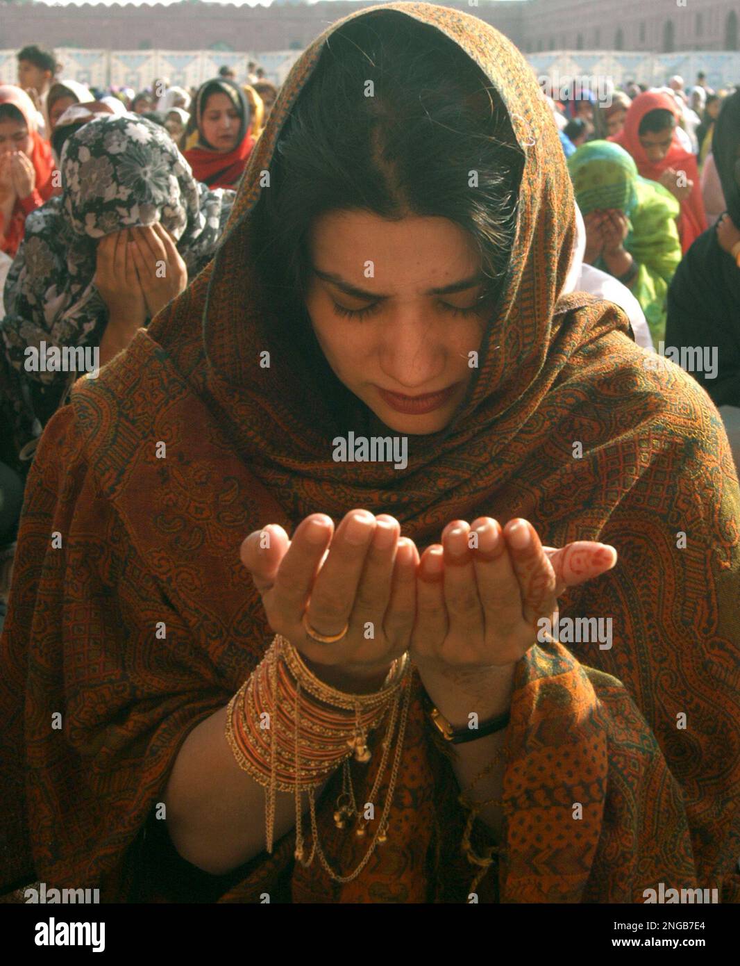 A Pakistani Muslim woman prays for the Oct. 8th earthquake victims at a ...