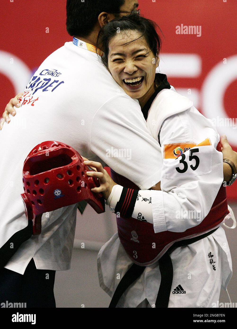 Taiwan's Yang Wenchen, right, hugs her coach after defeating South Korea's Jung Sunyoung ...