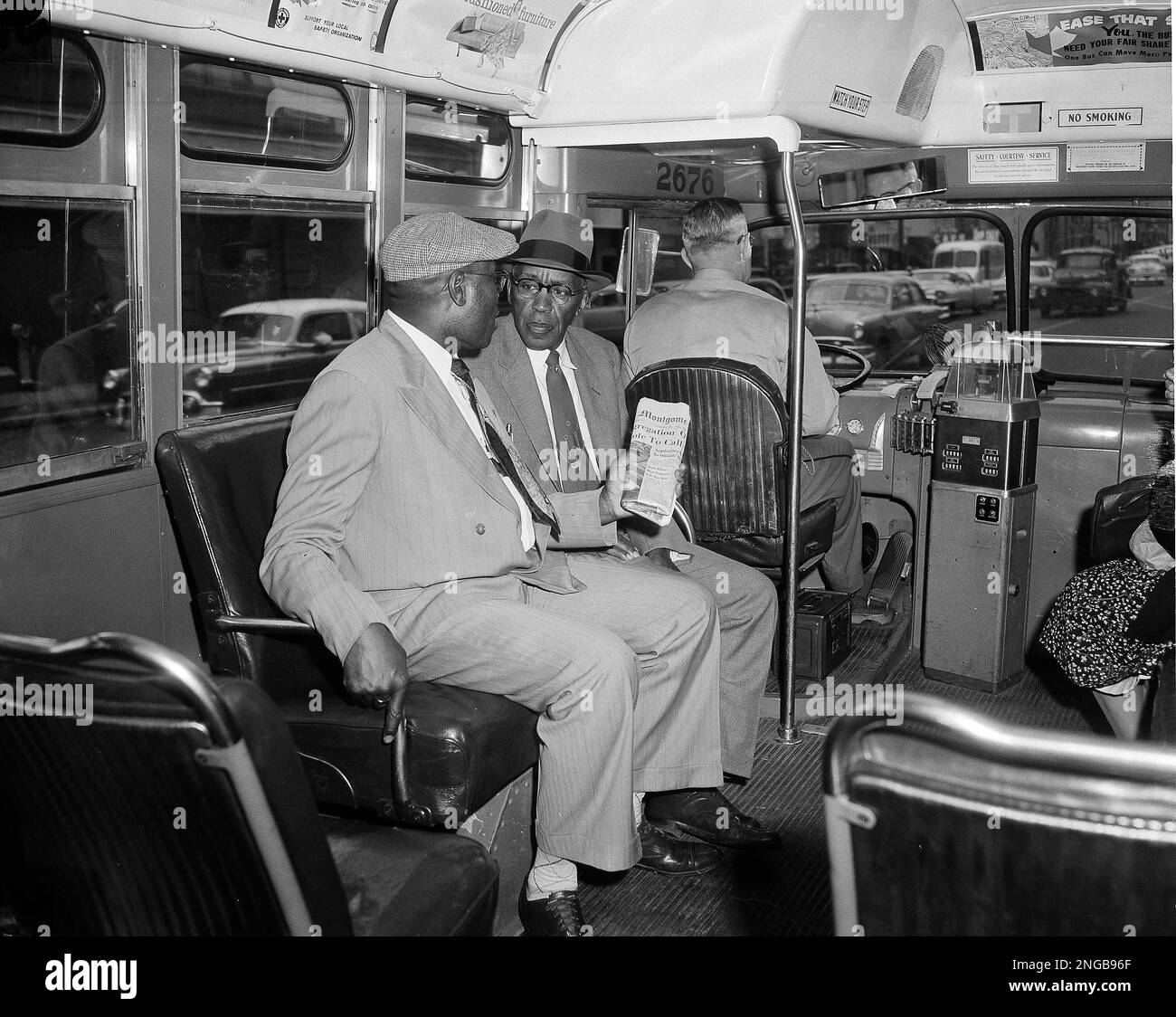Two unidentified black men sit in the first seat behind the driver of a ...