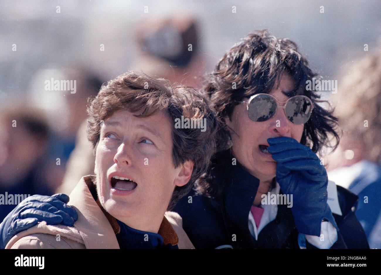 Two unidentified spectators at the Kennedy Space Center react after ...