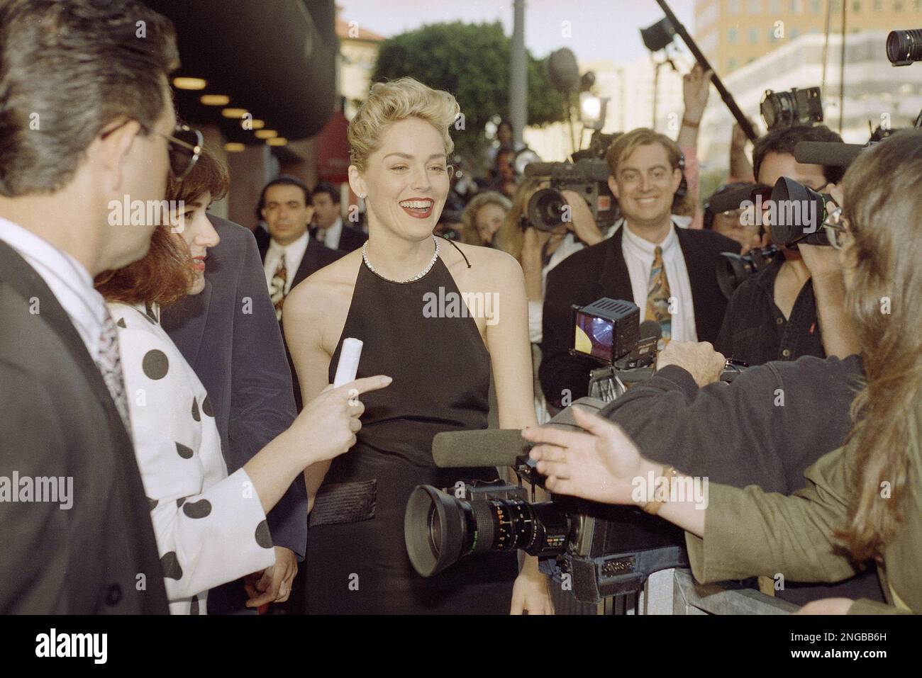 Actress Sharon Stone, center, is surrounded by media as she arrives at ...