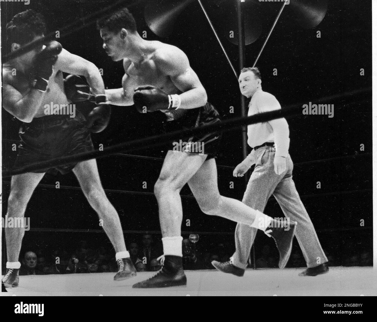 World heavyweight boxing champion Joe Louis, right, lands a right to ...
