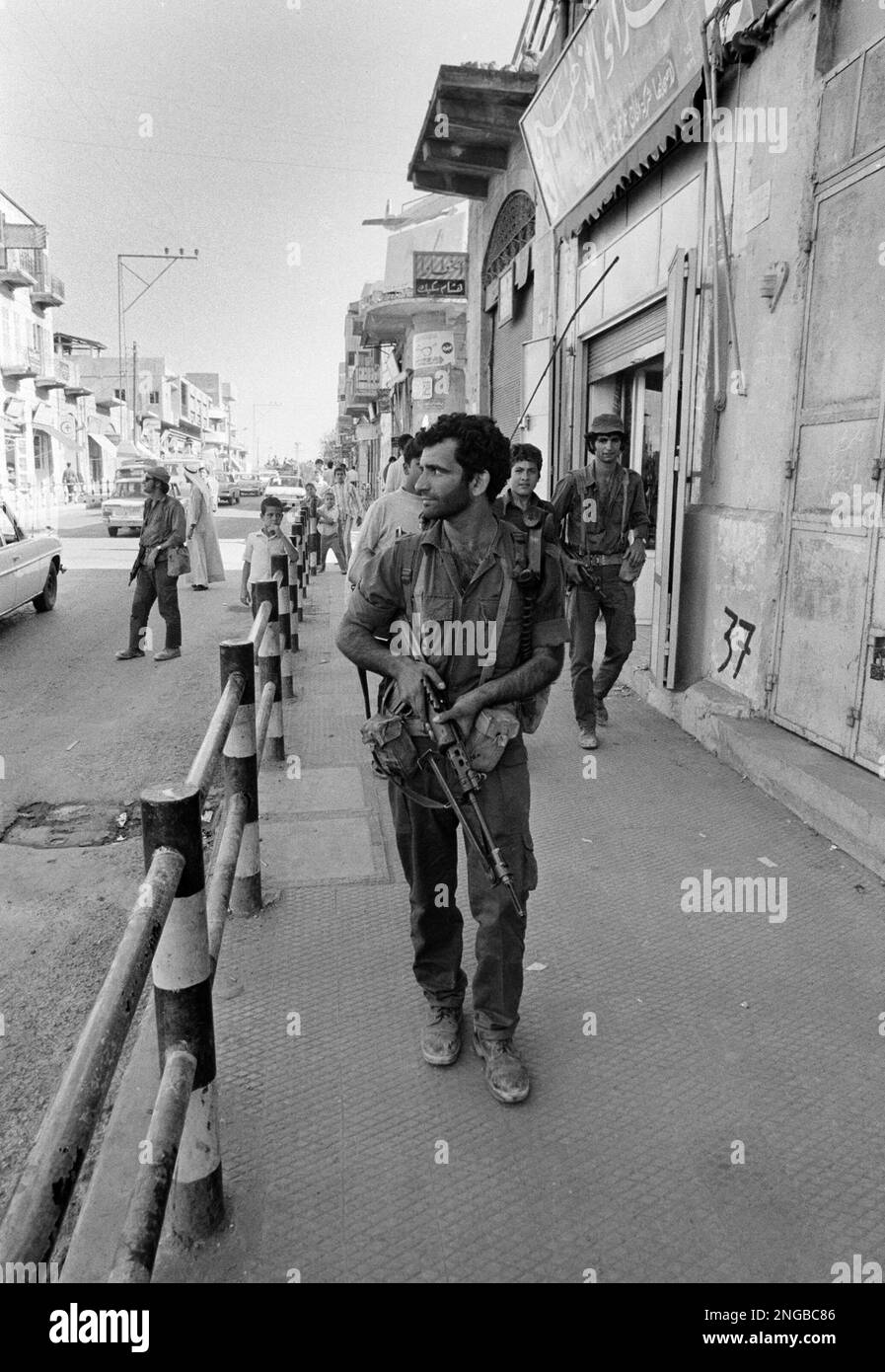 A heavily armed Israeli soldier patrols the main street of Israeli ...