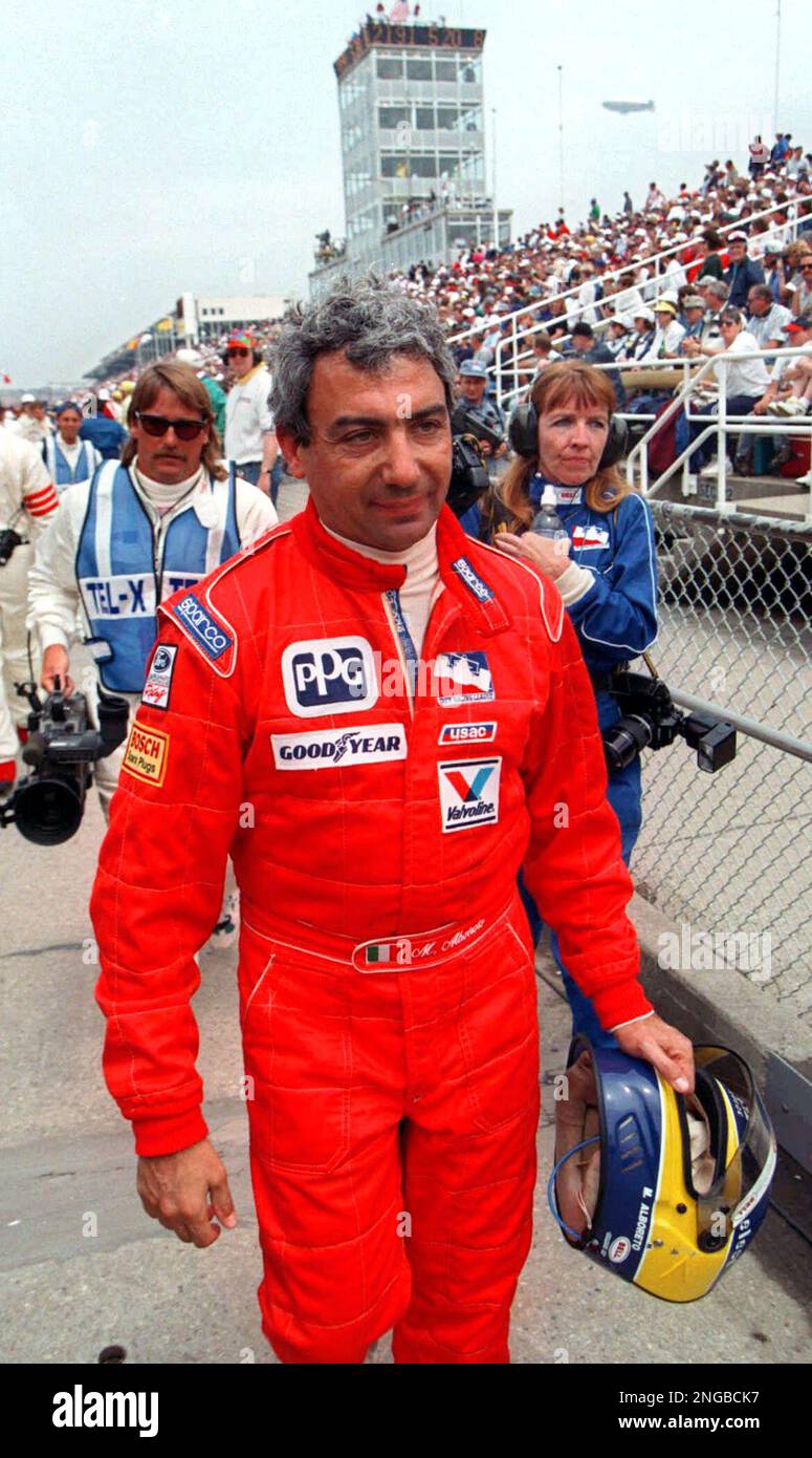 Ferrari F1 driver Michele Alboreto of Italy walks through the pits ...