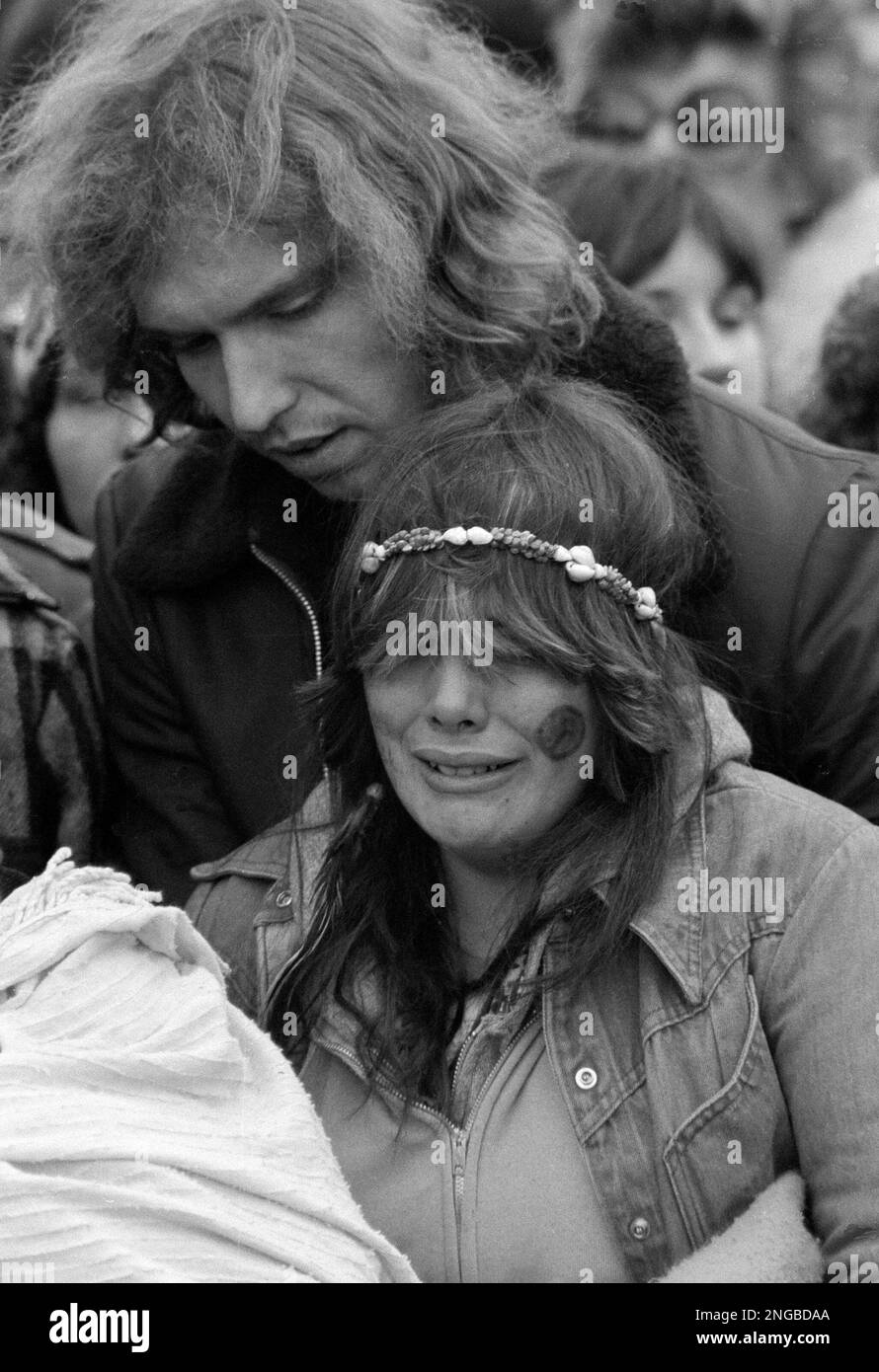 A young woman is comforted as she is overcome with emotion during the ...