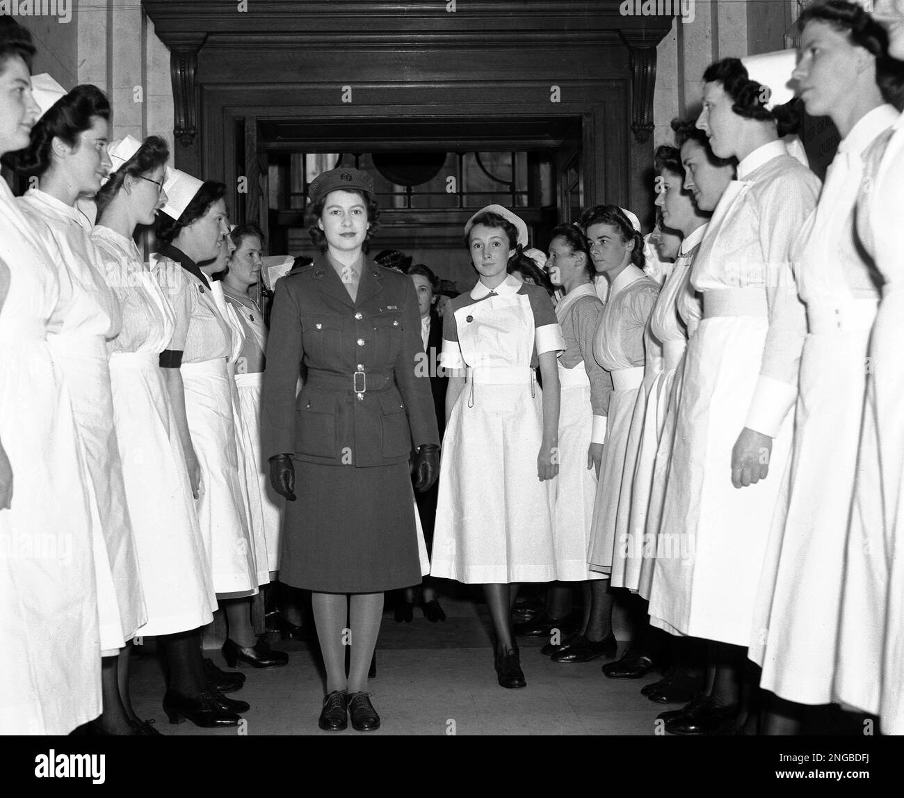 Britain's Princess Elizabeth passes through a guard of honour of nurses ...