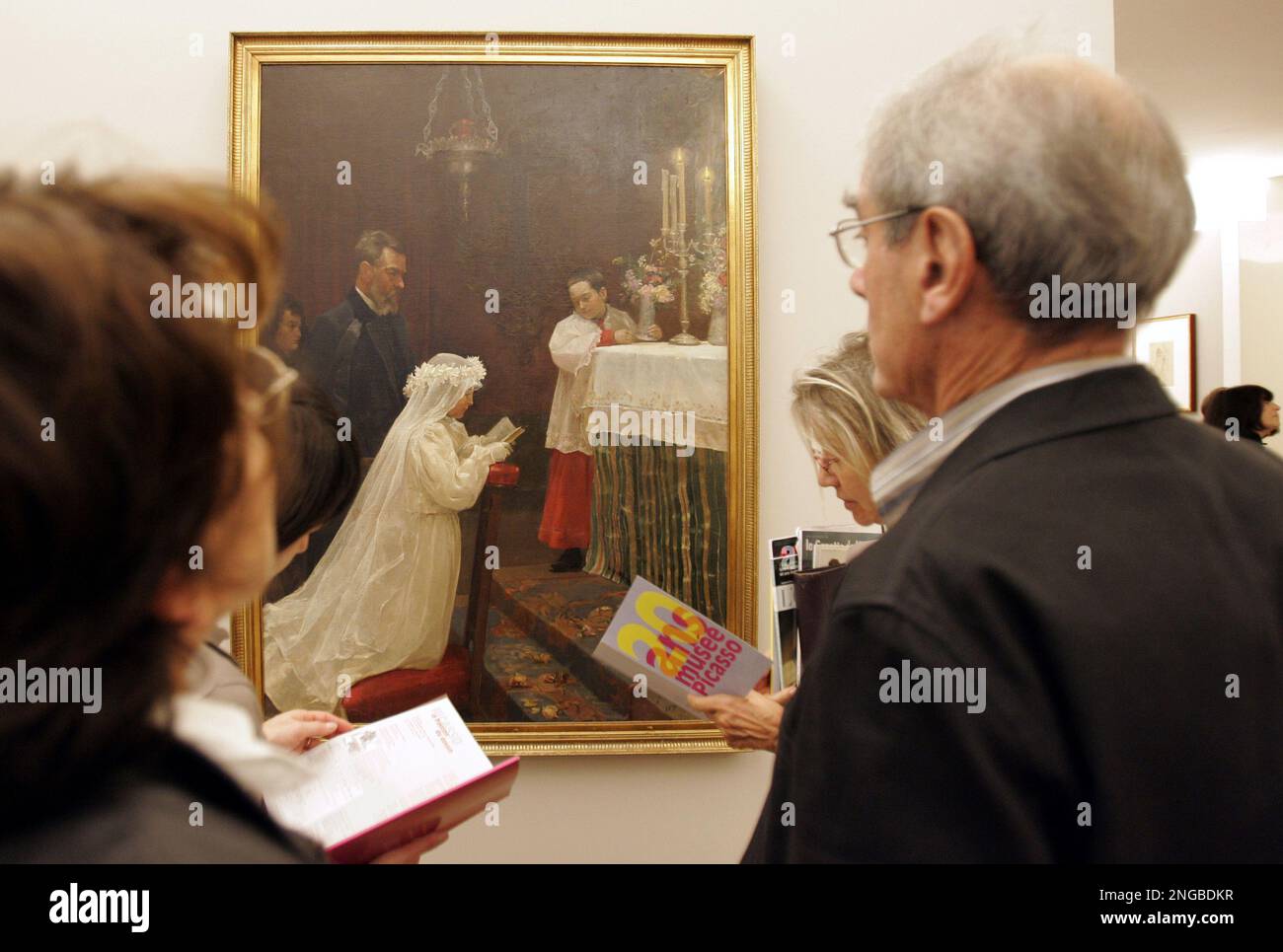 Visitors look at "The first communion", a 1896 oil on canvass by Pablo ...
