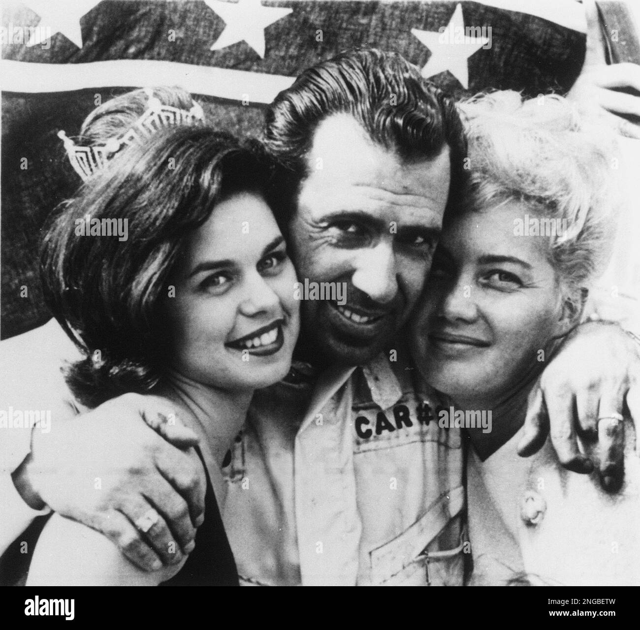 Ned Jarrett gets hugs from his wife, Martha, right, and Vicki Johnson ...