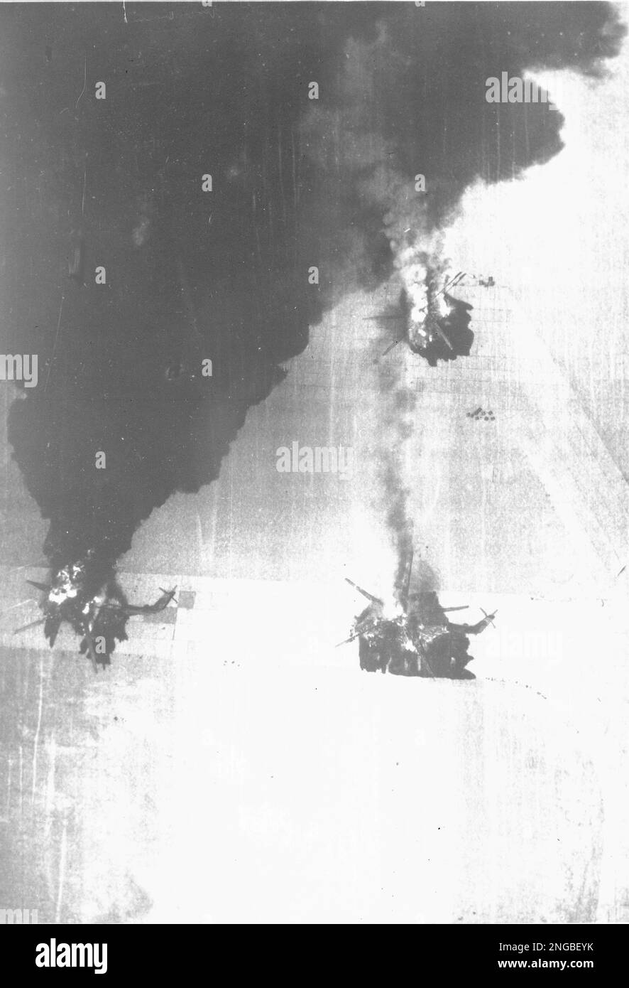 Helicopters belch smoke and flames on an unidentified airfield after it ...