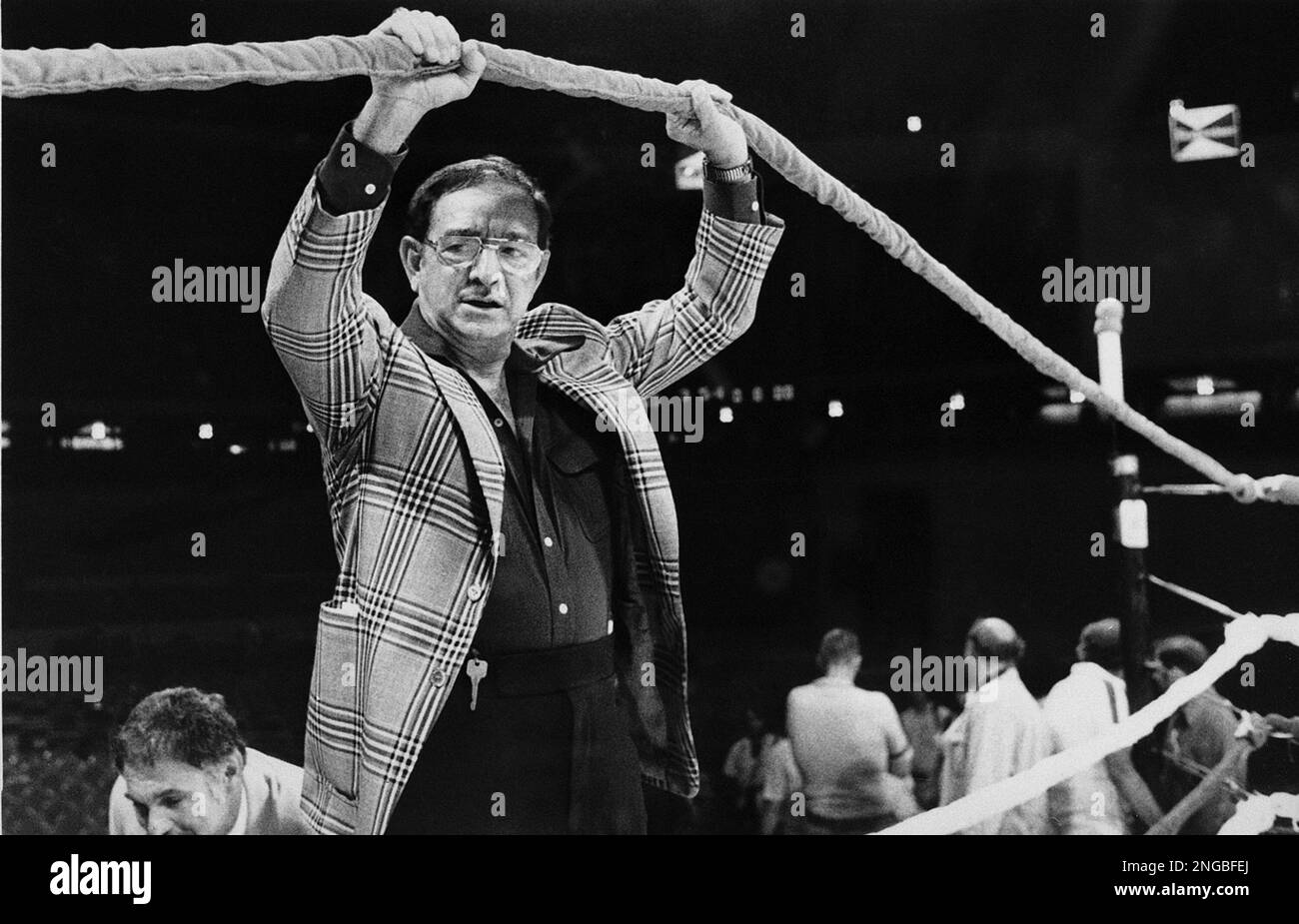 Angelo Dundee, trainer of Muhammad Ali stretches the ropes of the ring ...