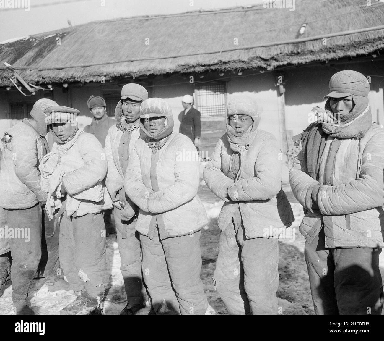 Chinese Communist troops wearing Manchurian winter equipment line up ...