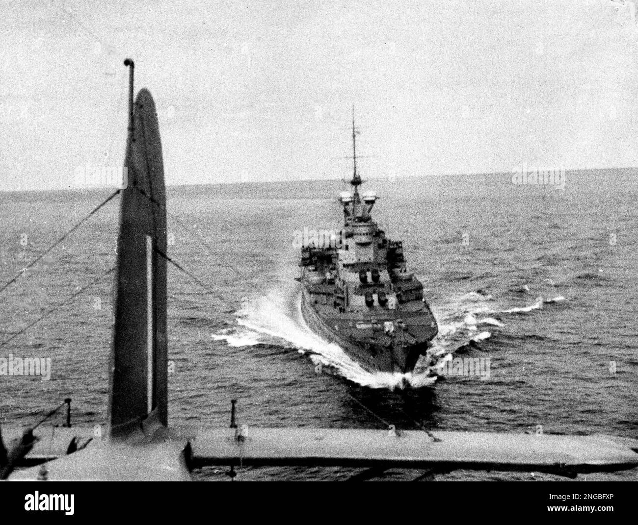 A Swordfish of the Royal Navy Fleet Air Arm flies past HMS Renown, a ...