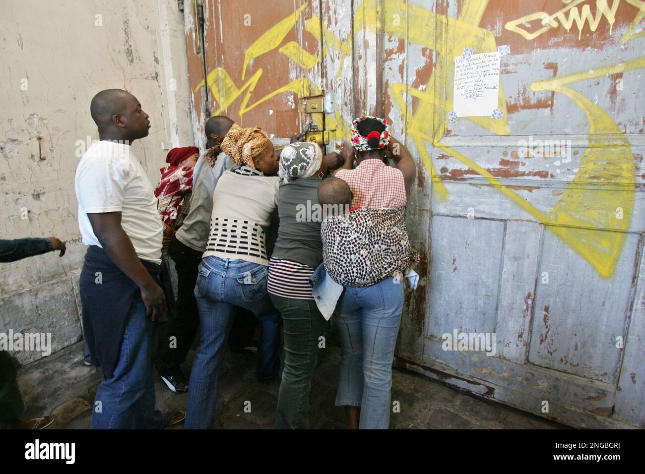 Africans block the access to police forces, at the main gate of a ...
