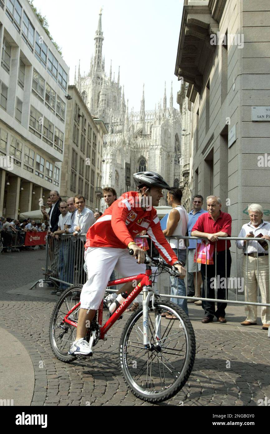Ferrari Brazilian driver Rubens Barrichello rides a bike on the ...