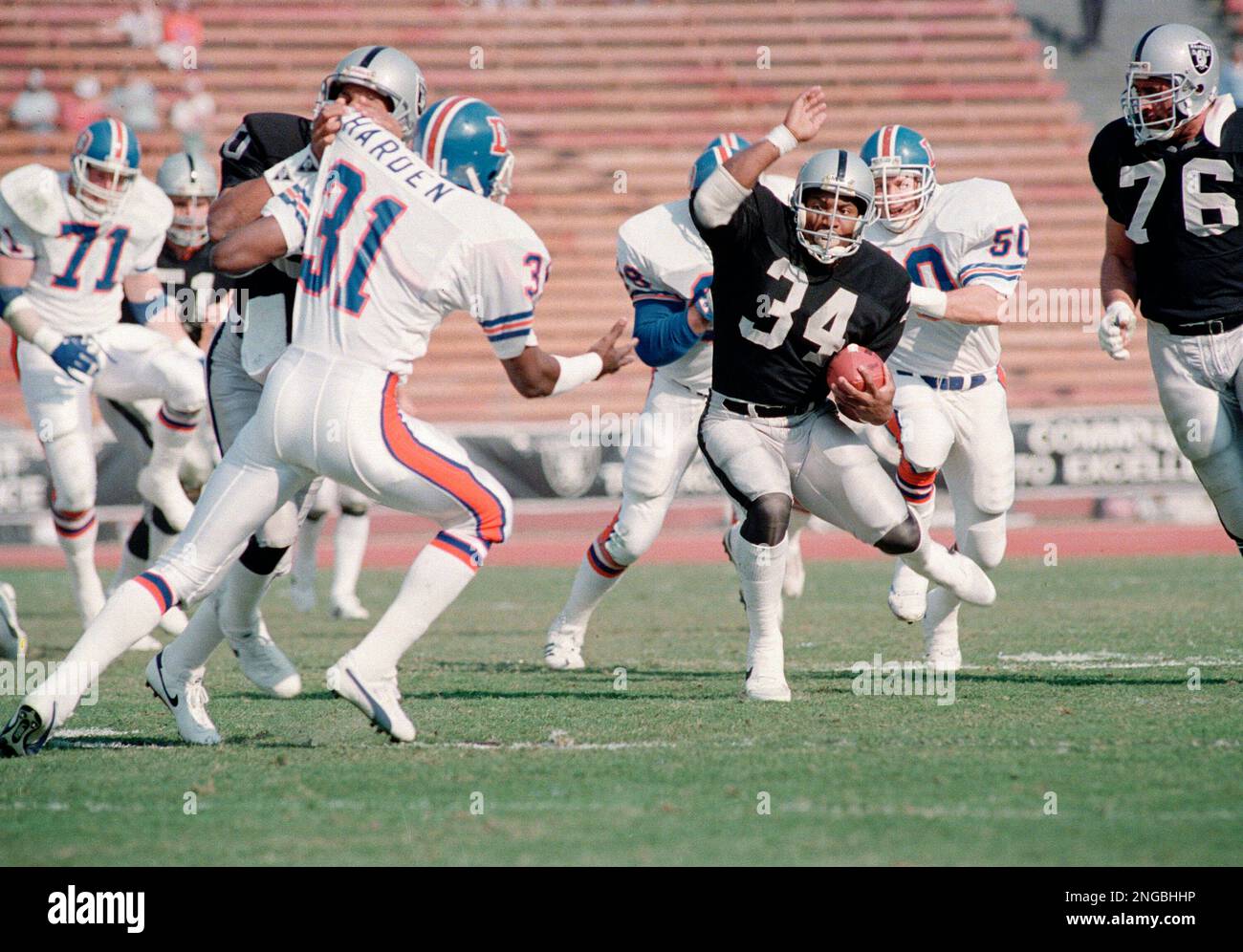 Los Angeles Raiders Bo Jackson is chased down by Ricky Hunley, left ...