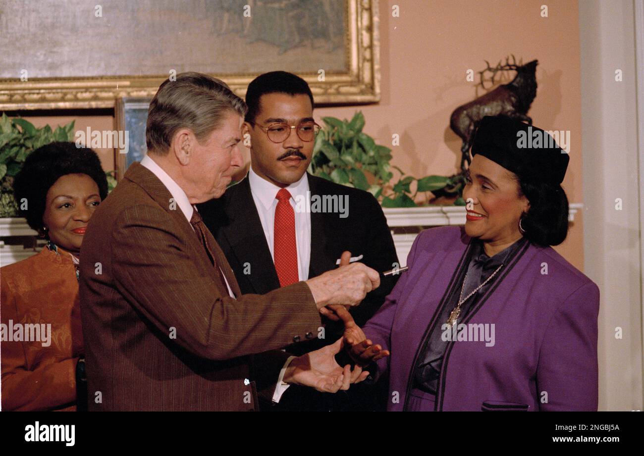 President Reagan hands Coretta Scott King the pen he used to sign the ...