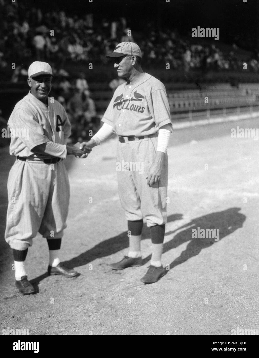 Adolfo Luque, left, greets Mike Gonzalez while in Cuba managing the ...
