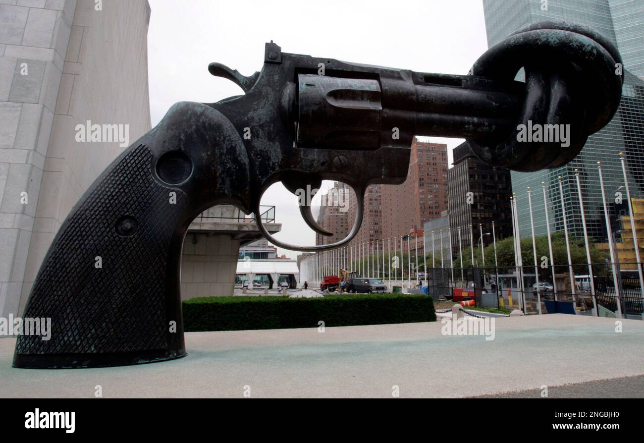 The sculpture of a hand gun with a knotted barrel is seen in front of ...