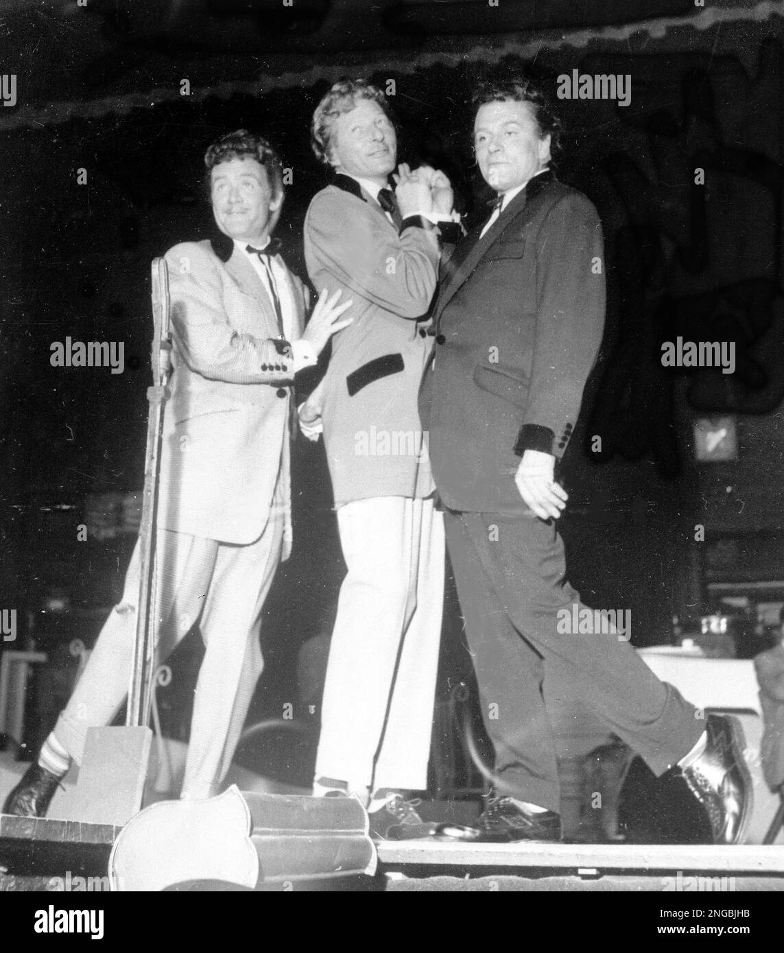 U.S actor Danny Kaye, centre, performs with British actors John Mills ...