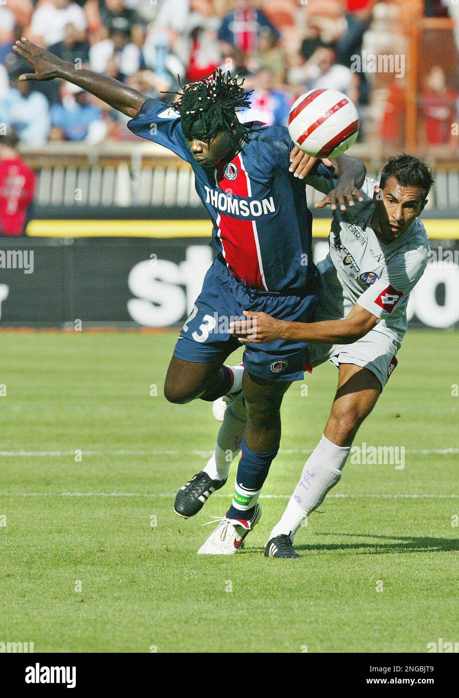 Psg's Modeste M'Bami, left, fights for the ball with Toulouse's Bryan ...