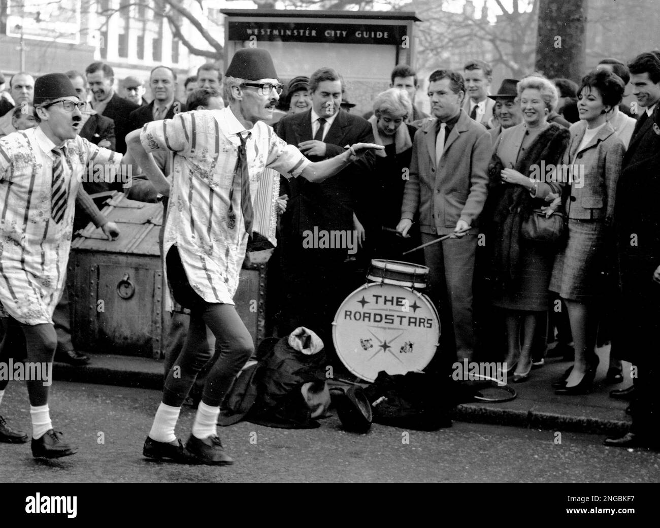 Actors and actresses watch a pair of buskers perform in Leicester ...
