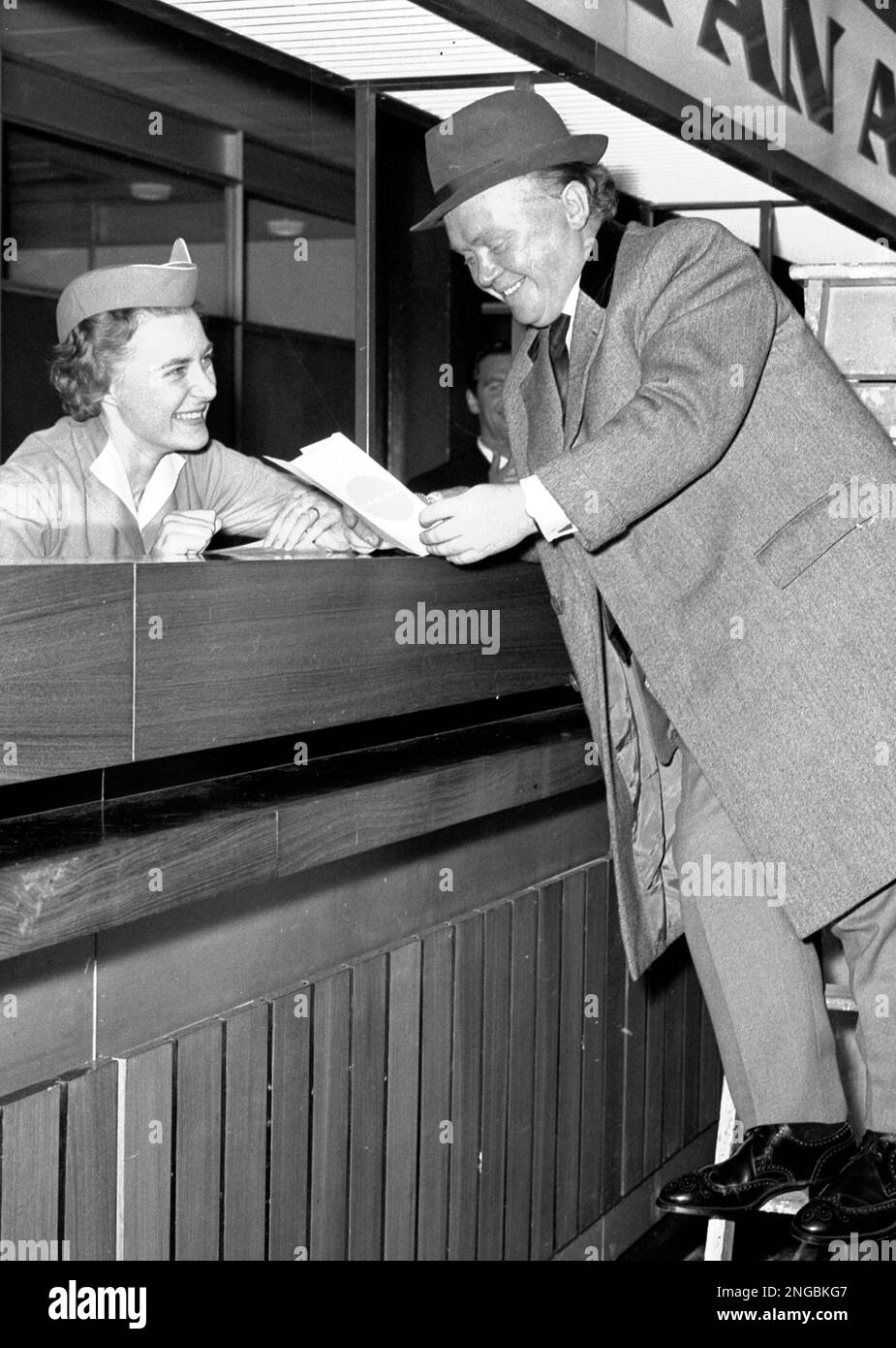 British comedian Charlie Drake uses a pair of step ladders to talk to ...