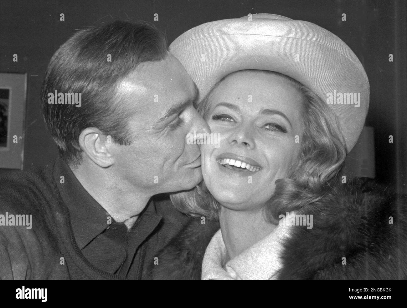 British actor Sean Connery kisses actress Honor Blackman at a party at ...