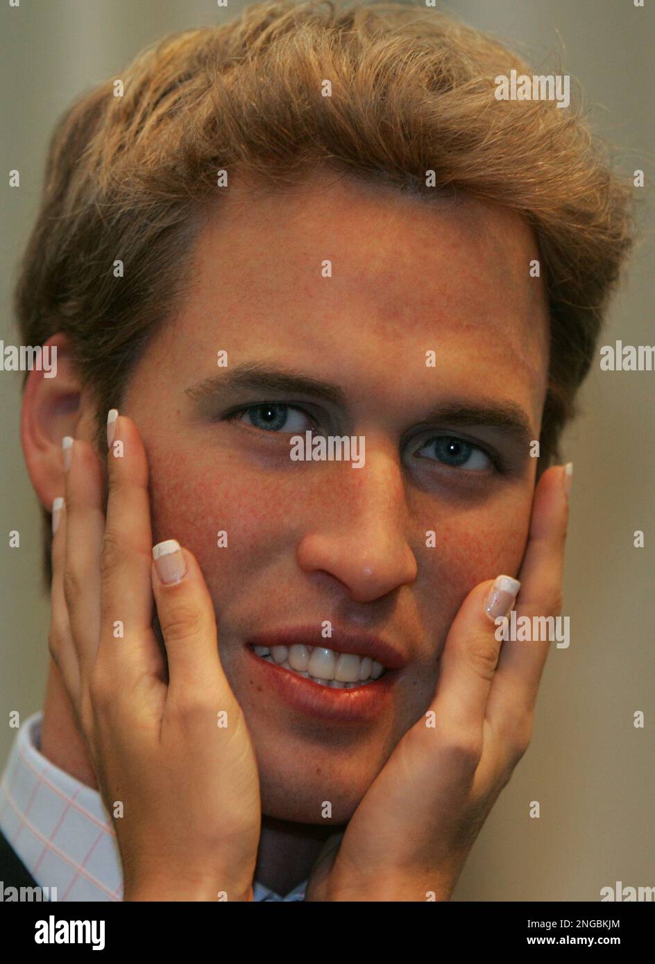 A female visitor touches the wax work model of Britain's Prince William ...