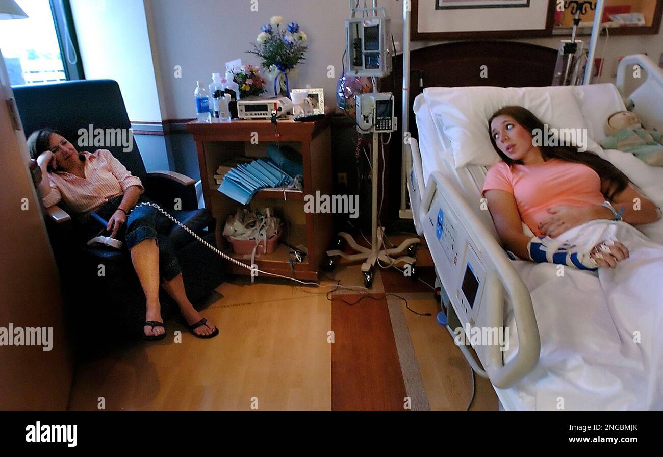 Emily Benton, right, 20, calls to her mother Patty Benton, left, as she ...