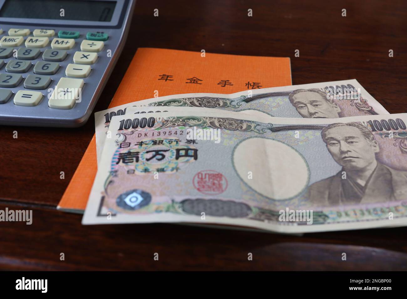 February 2023, Tokyo, Japan.Japanese pension book and cash on the table ...