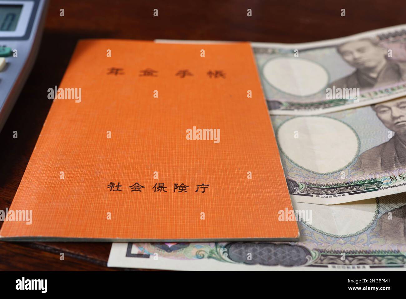 February 2023, Tokyo, Japan.Japanese pension book and cash on the table ...