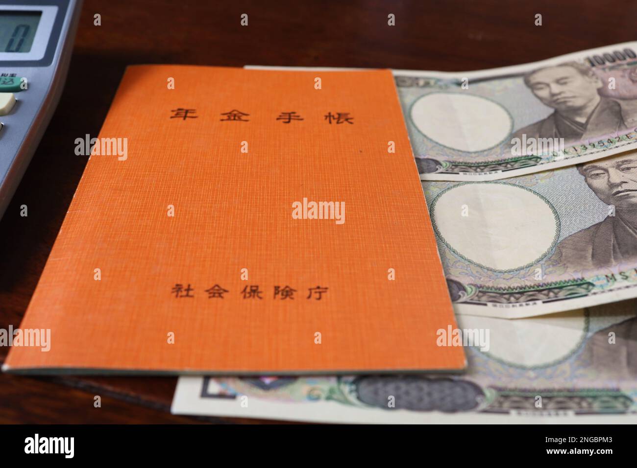 February 2023, Tokyo, Japan.Japanese pension book and cash on the table ...