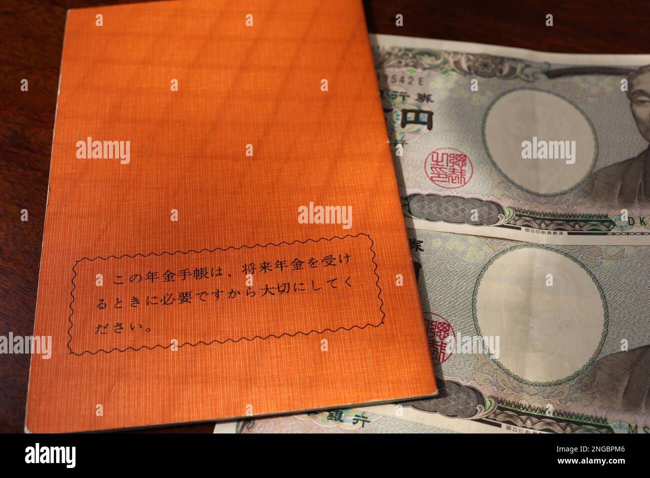 February 2023, Tokyo, Japan.Japanese pension book and cash on the table ...