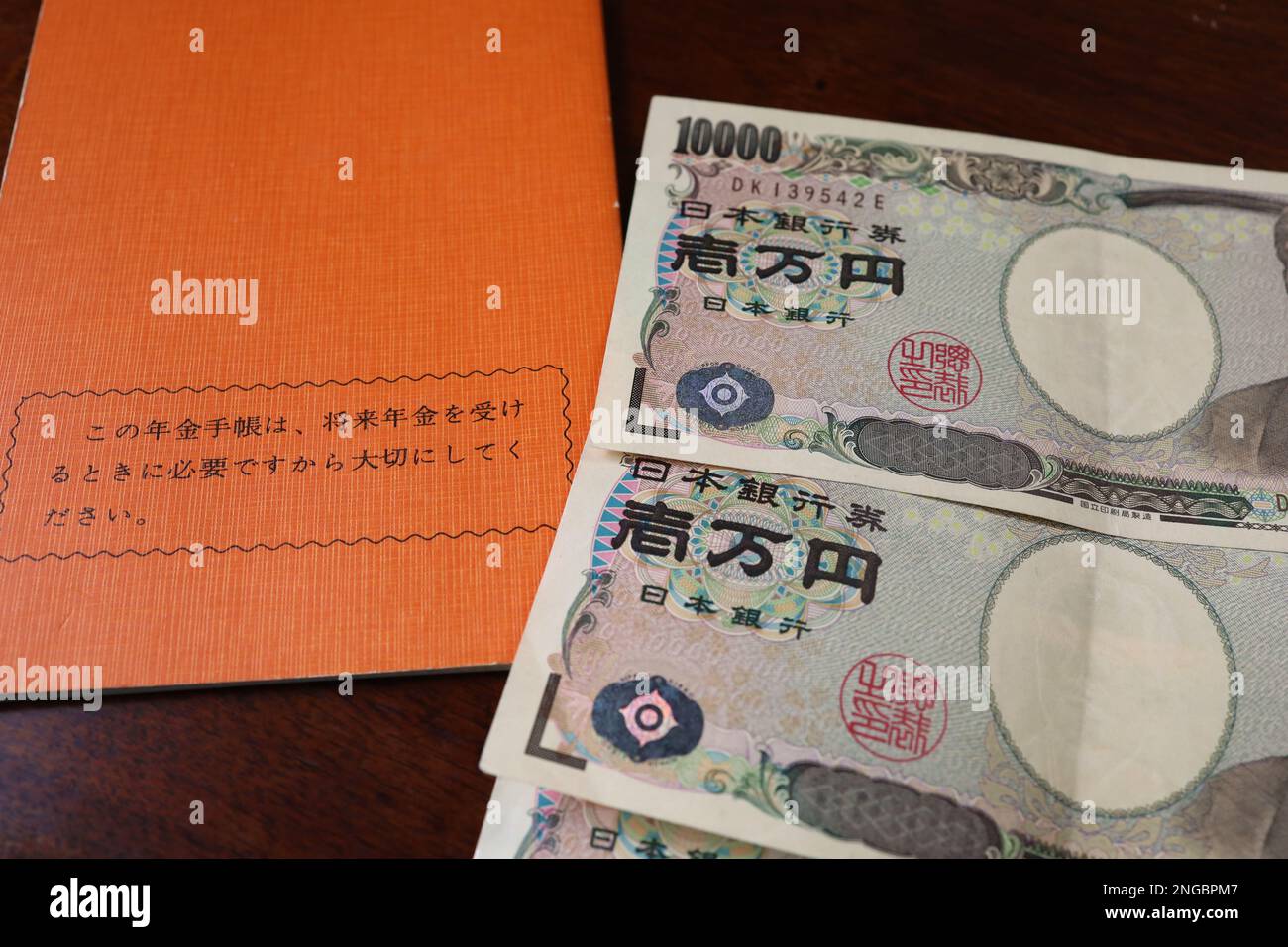 February 2023, Tokyo, Japan.Japanese pension book and cash on the table ...