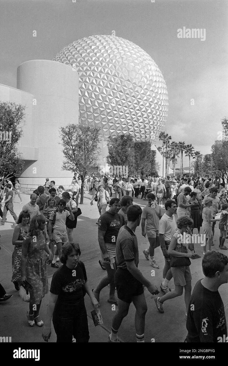 Visitors to EPCOT pass beneath Spaceship Earth during the opening day ...