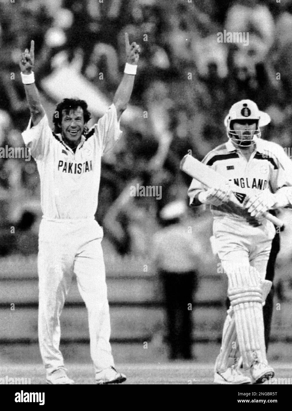 Pakistan captain Imran Khan, left, raises his arms in triumph, as ...