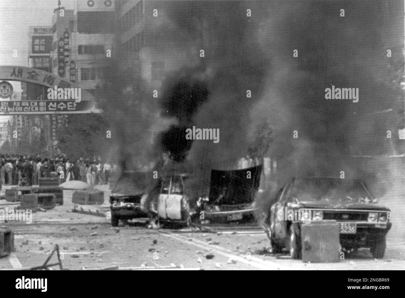 Cars burn on the streets of Kwangju, South Korea, May 19, 1980, as anti ...
