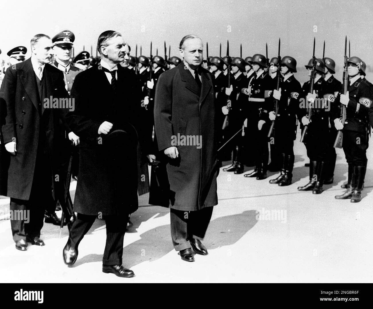 Britain's Prime Minister Neville Chamberlain, second left, passes a ...