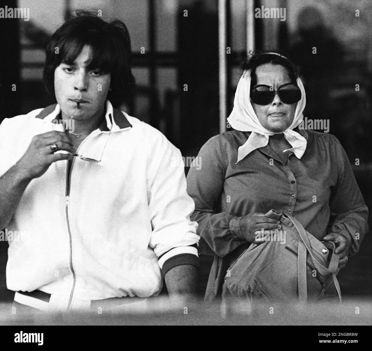 Marjorie Caldwell is escorted by her son Ricky as she leaves the Dakota ...
