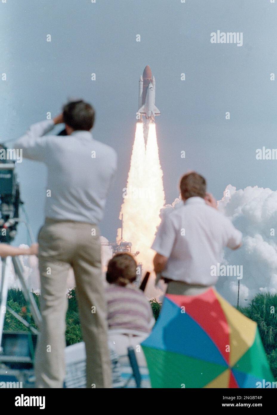 Spectators watch the successful ascent of the space shuttle Discovery ...