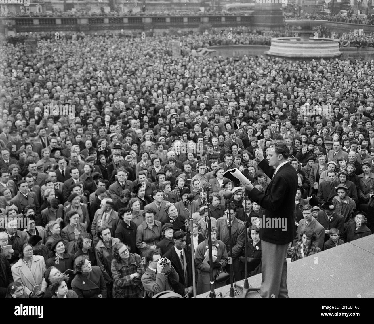 American evangelist Billy Graham reads passages from the Bible to a ...
