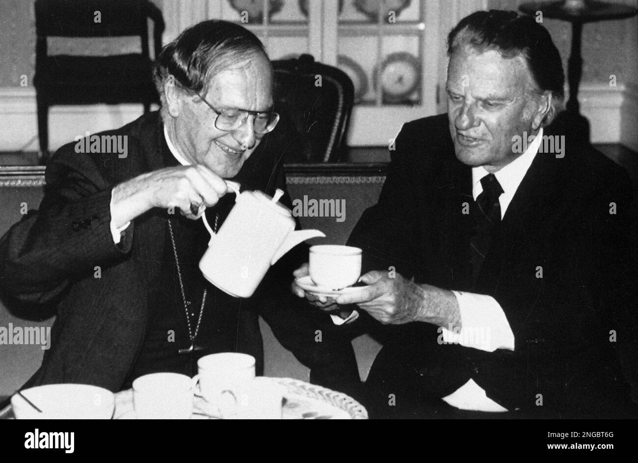 Dr. Robert Runcie, the Archbishop of Canterbury, serves coffee to ...