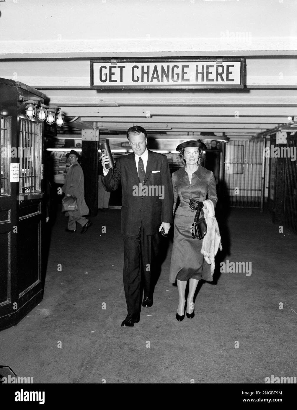 Evangelist Billy Graham and his wife Ruth walk through a subway passage ...