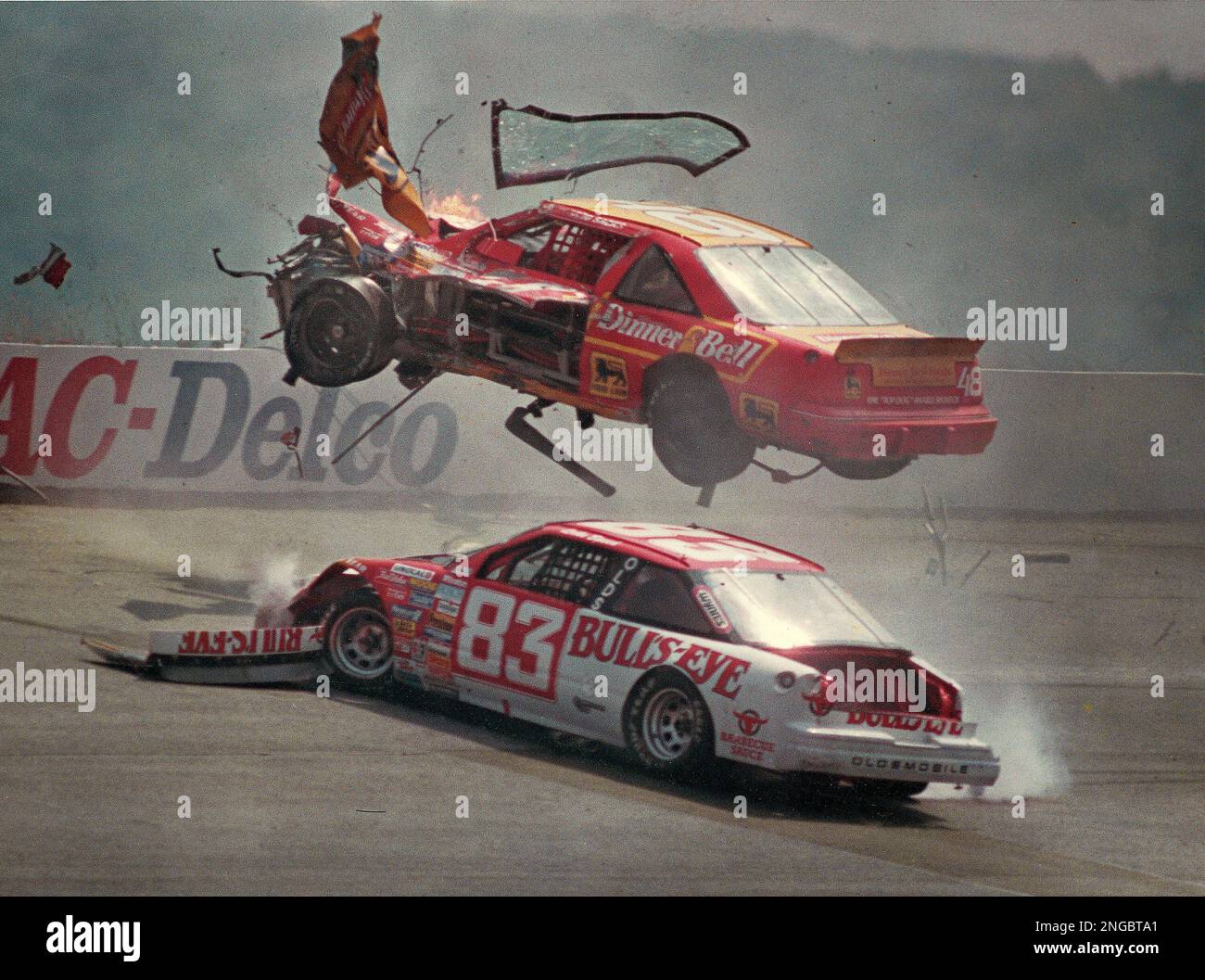 The car of Greg Sacks sails over Lake Speed's wrecked car at Pocono ...