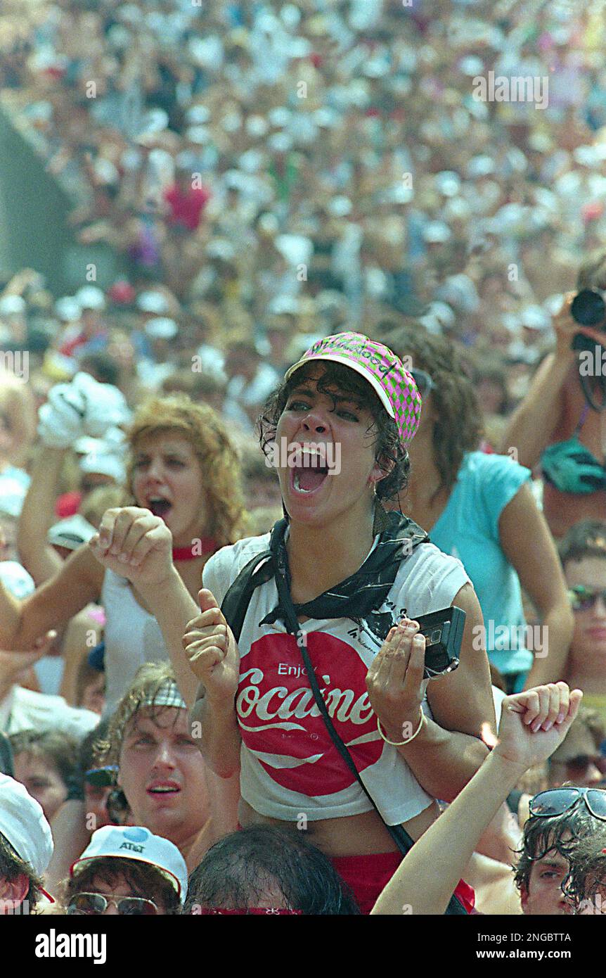 A shouting female fan, wears a Coca-Cola cocaine parody shirt in the ...