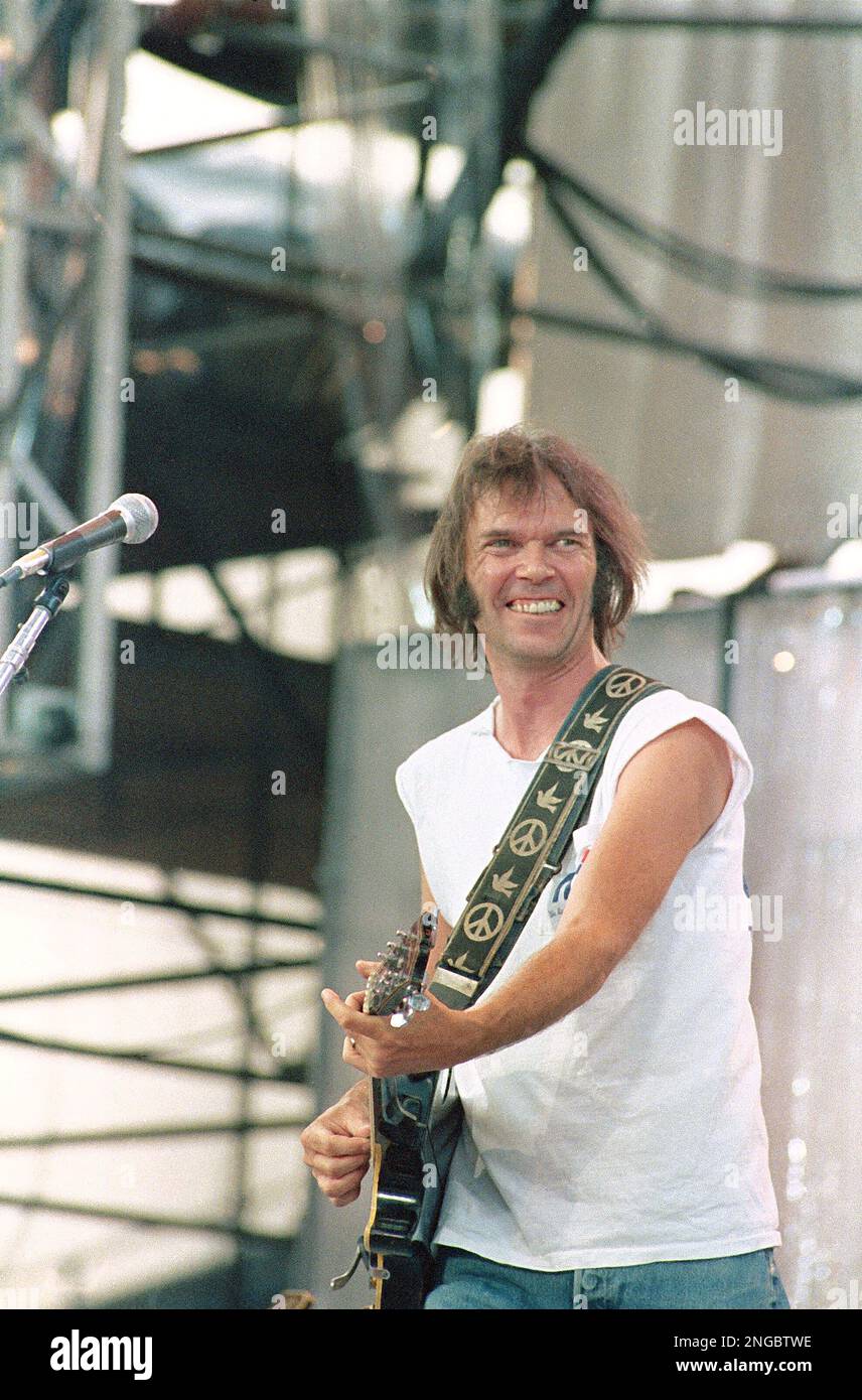 Canadian singer-songwriter Neil Young, playing a Gibson Les Paul guitar ...