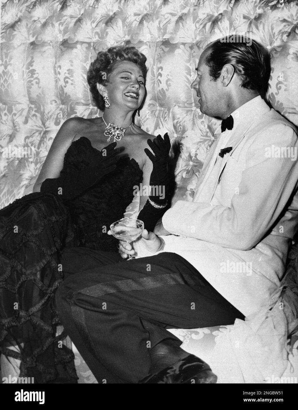 Actress Stella Adler talks with actor Rex Harrison at a party given for ...