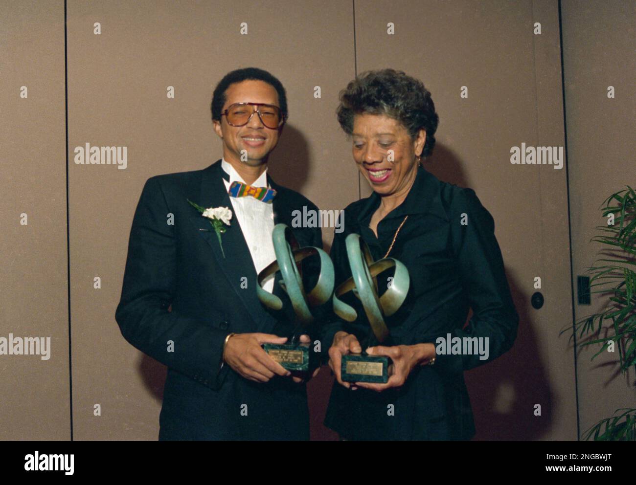 Tennis players Arthur Ashe, left, and Althea Gibson pose while holding ...